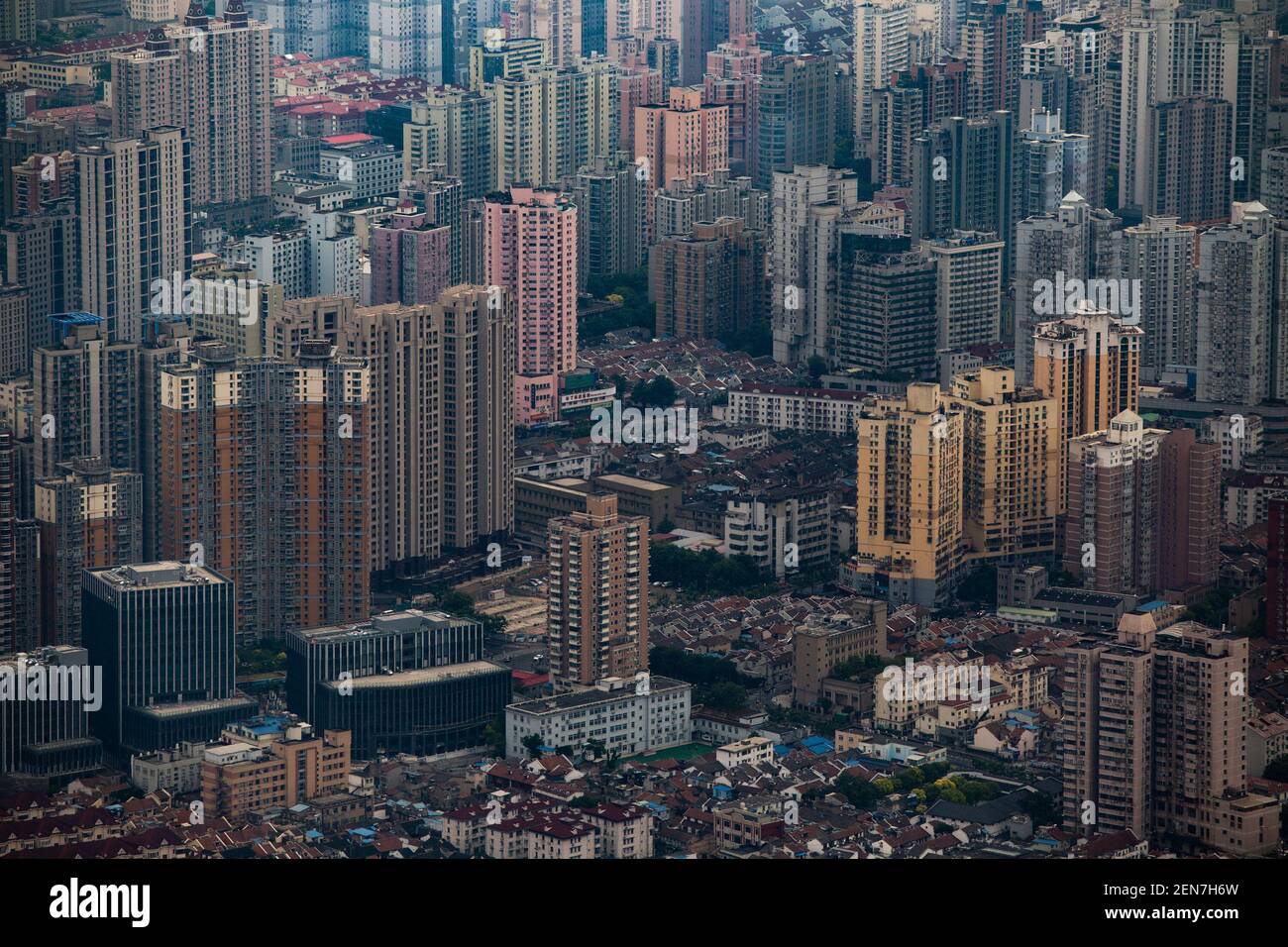 Residential houses in longtang are embraced by skyscrapers and high ...