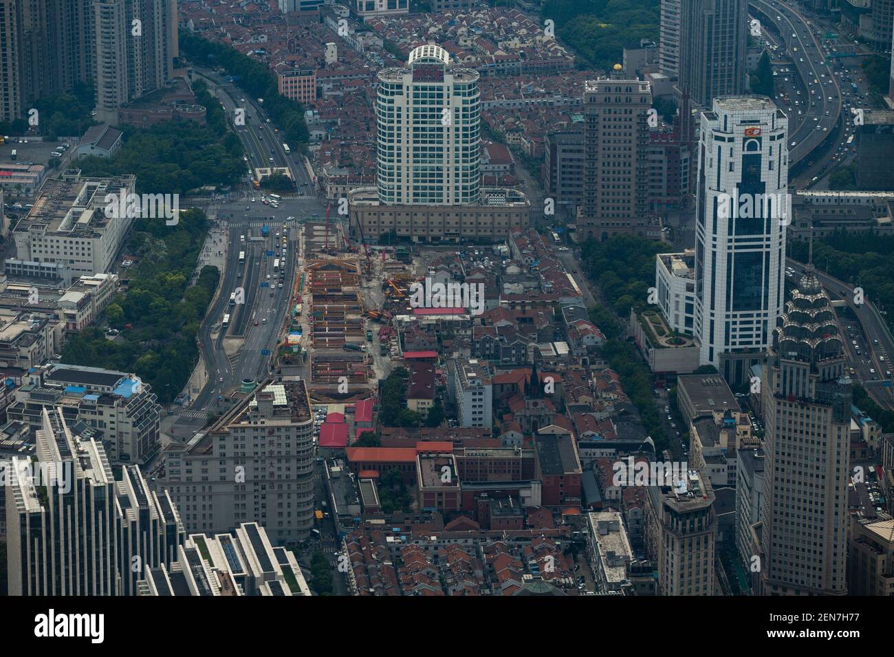 Residential houses in longtang are embraced by skyscrapers and high ...