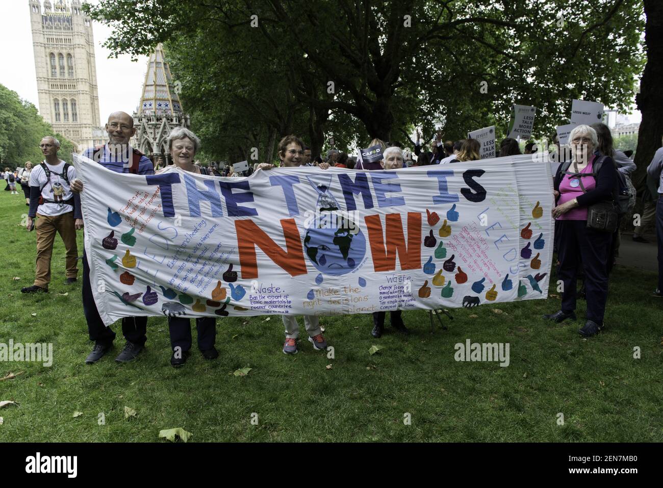 Environmental protesters hold a banner saying the Time Is Now during ...