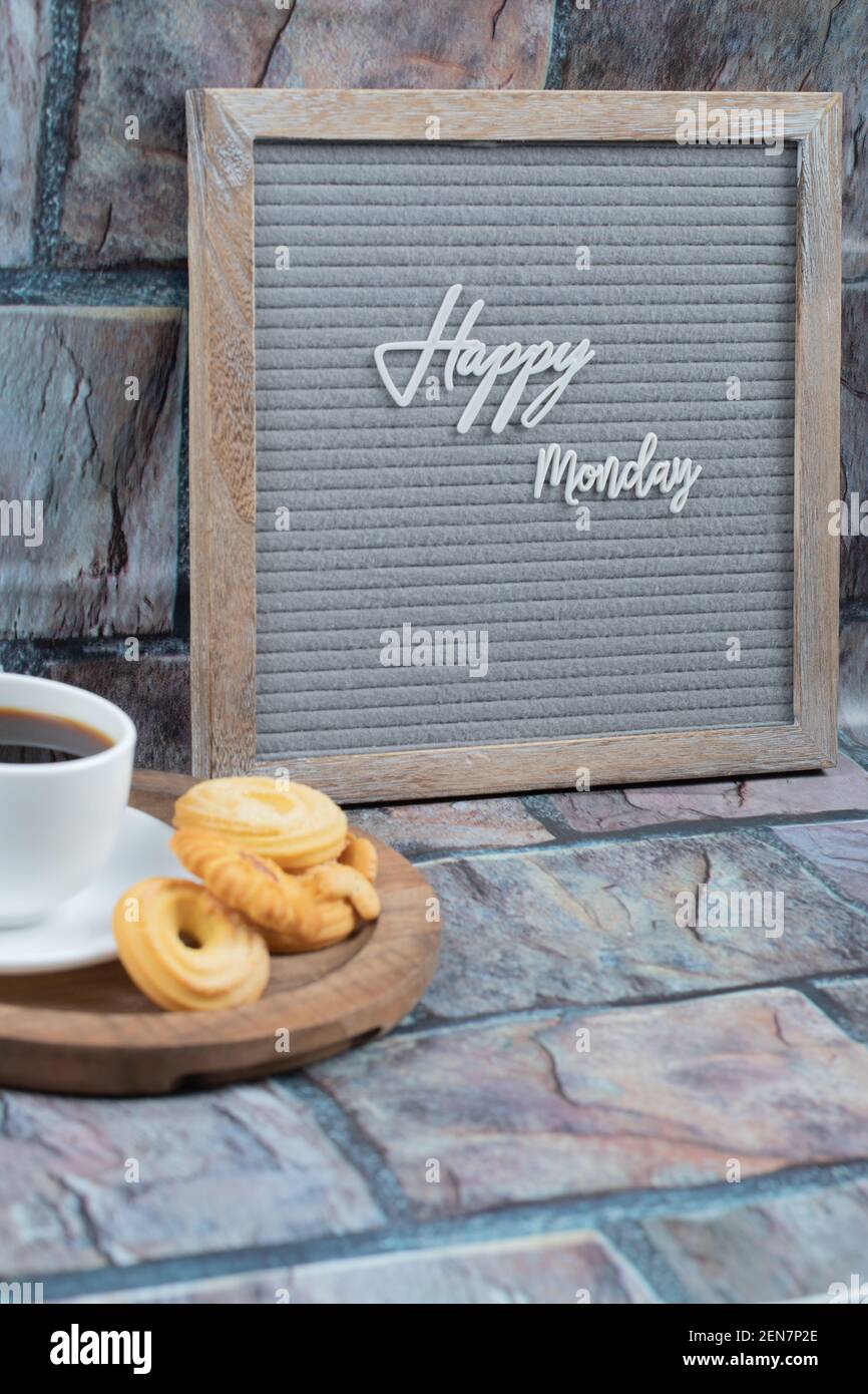 Happy monday poster with a cup of drink and cookies around Stock Photo ...