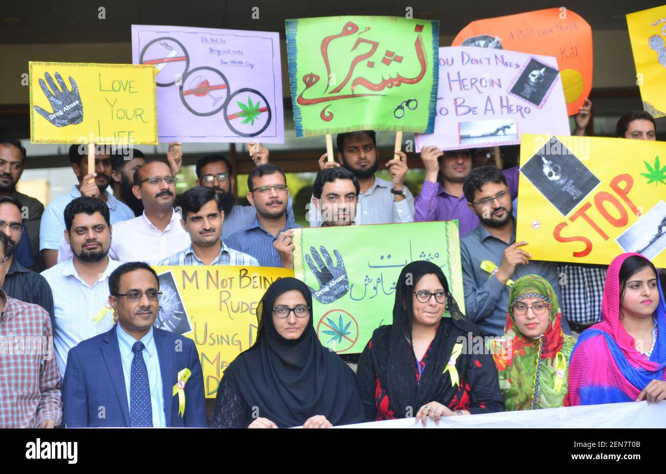 Members and officers of Punjab Forensic Science Agency hold banners ...