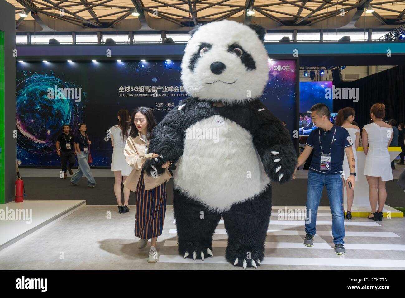 A Chinese worker dressed in giant panda costumes poses during the 2019 Mobile World Congress ...