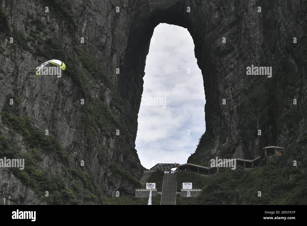 A wingsuit flyer jumps from a high place to glide through the air ...