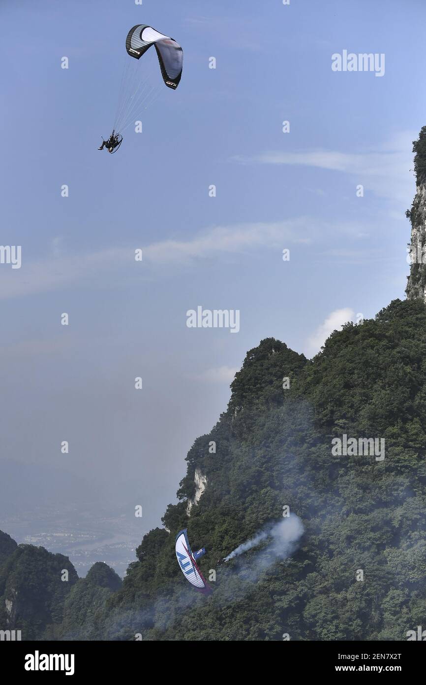 A wingsuit flyer jumps from a high place to glide through the air ...