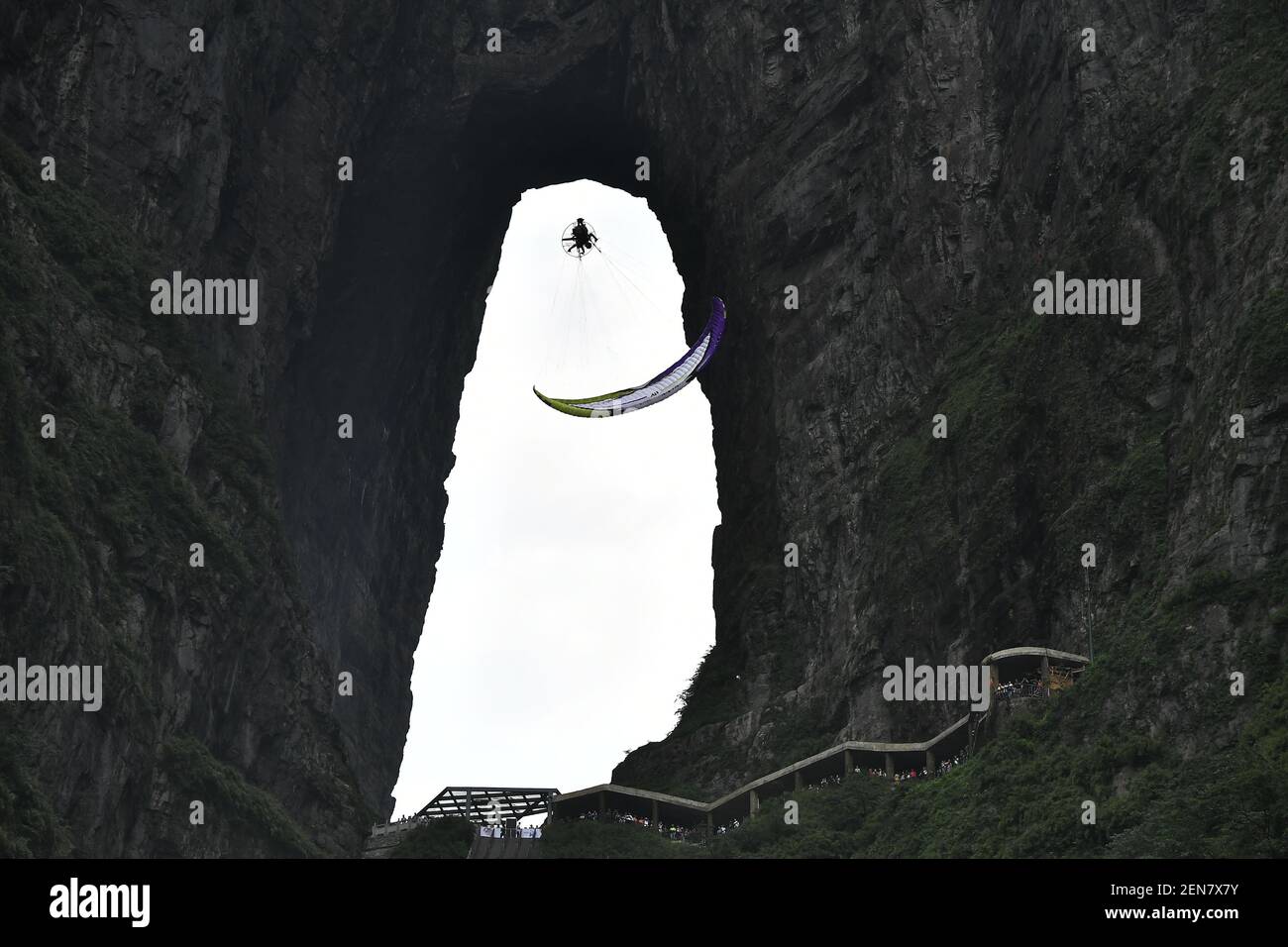 A wingsuit flyer jumps from a high place to glide through the air ...