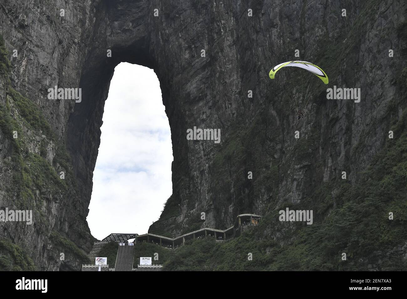 A wingsuit flyer jumps from a high place to glide through the air ...