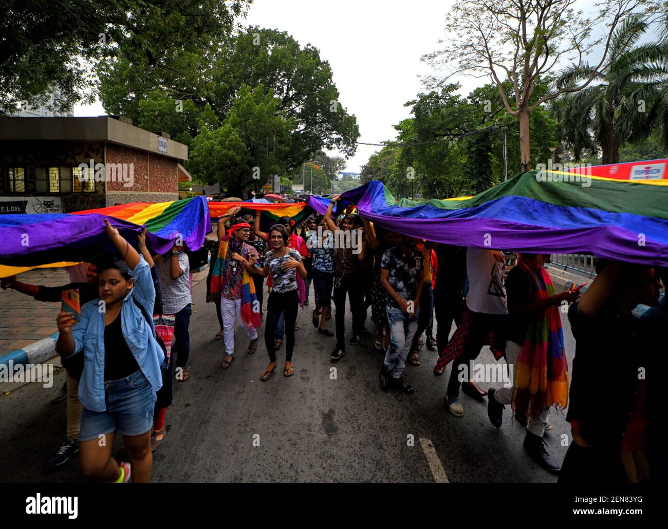 LGBT Community members seen carrying the colorful flags under heavy ...