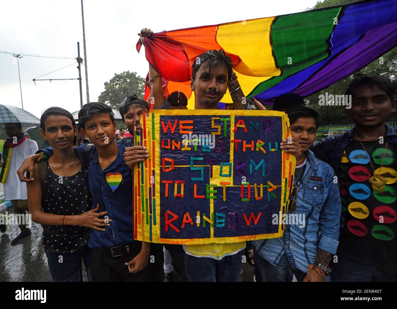 LGBT Community members seen walking with a colorful placard & a large ...