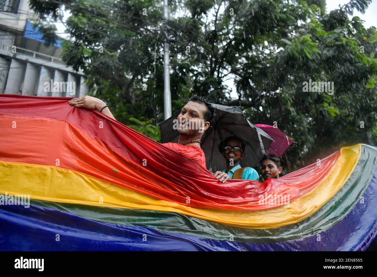 LGBTQ community members celebrate with a rainbow coloured flag as they ...