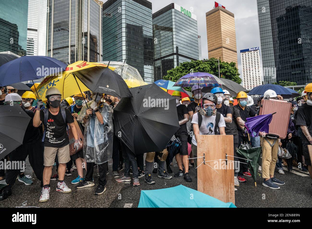 Anti government protesters using umbrellas and homemade shield to ...