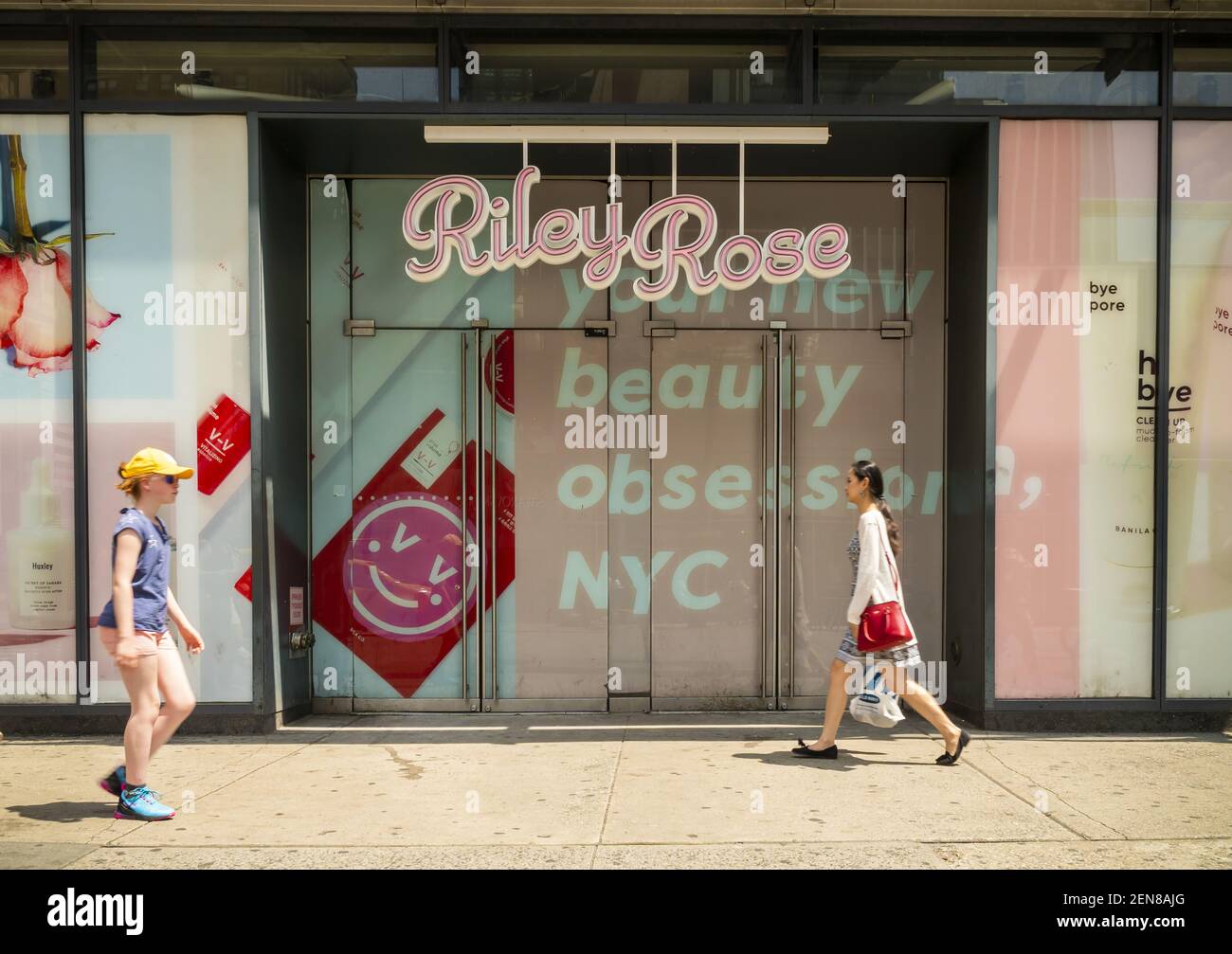 Signage on a storefront announces the imminent arrival of a Riley Rose ...
