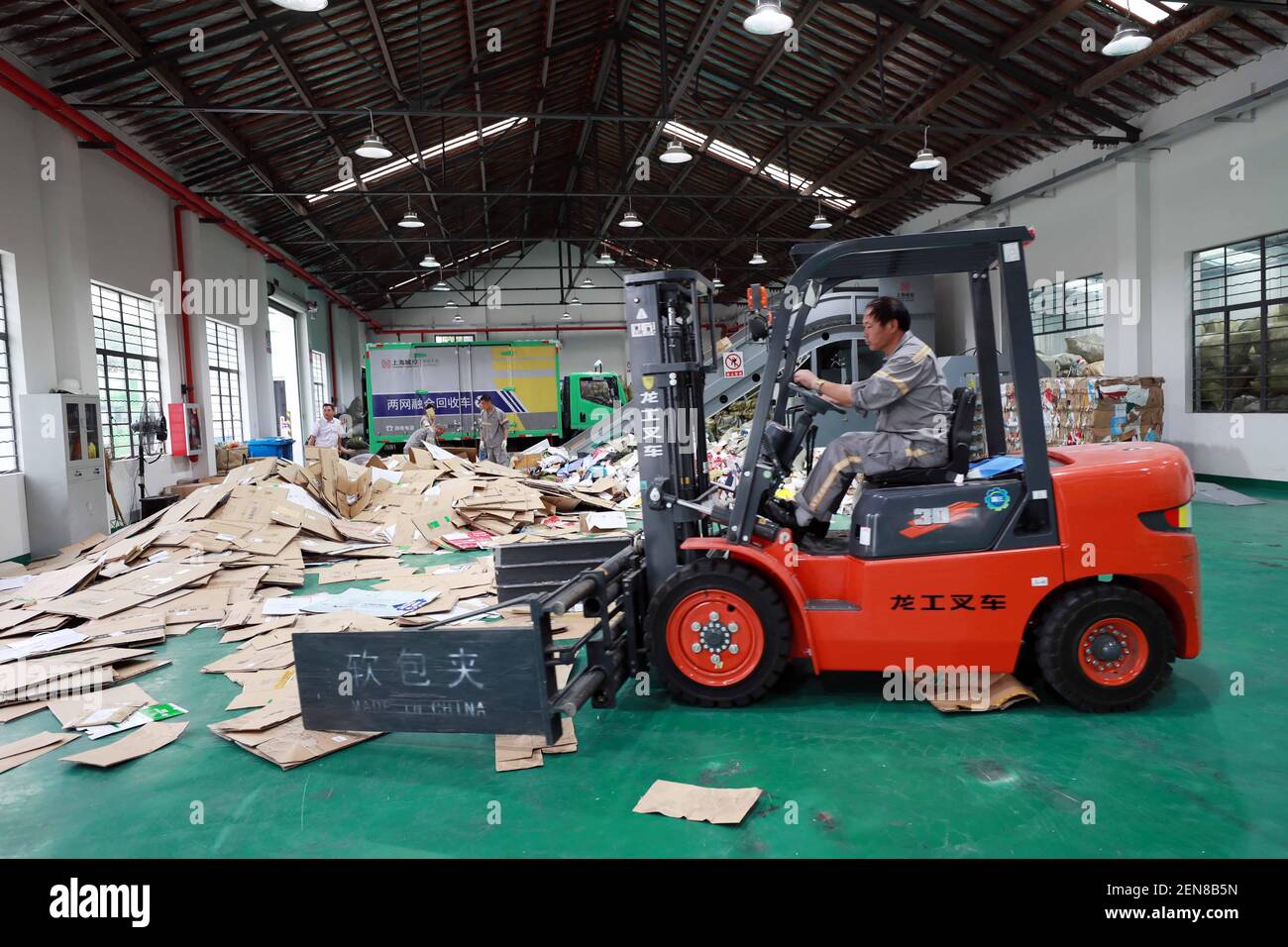 A Chinese worker sorts out recycling waste at a distribution center of ...