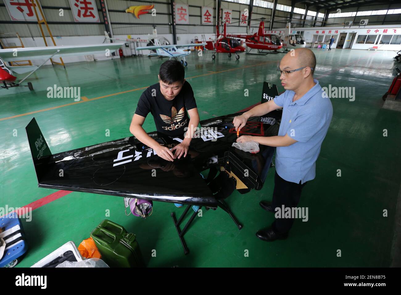 Chinese athlete Sheng Guangqiang checks a jetwing powered by turbojet ...