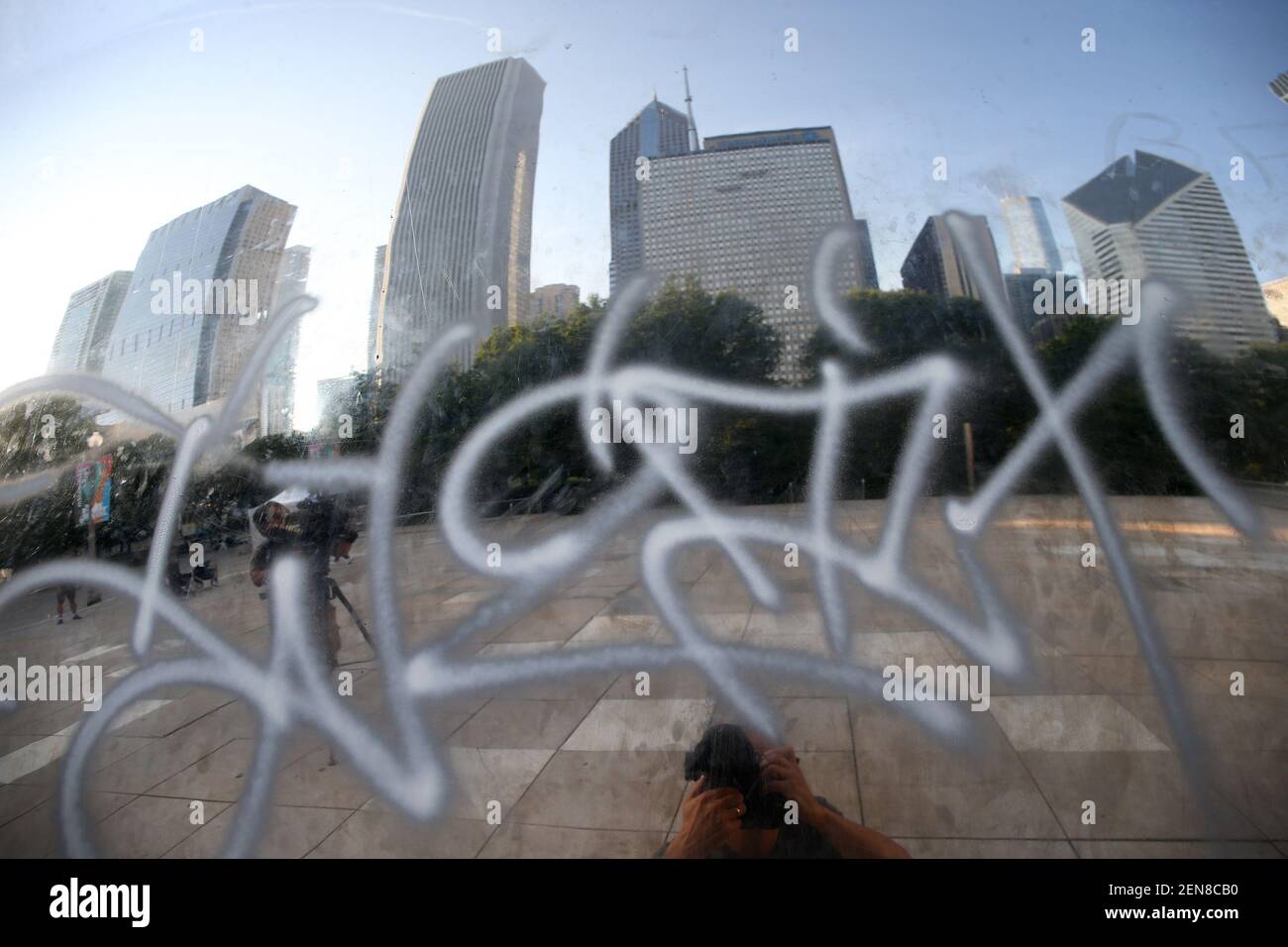 Graffiti mars the side of the Cloud Gate sculpture at Millennium Park ...