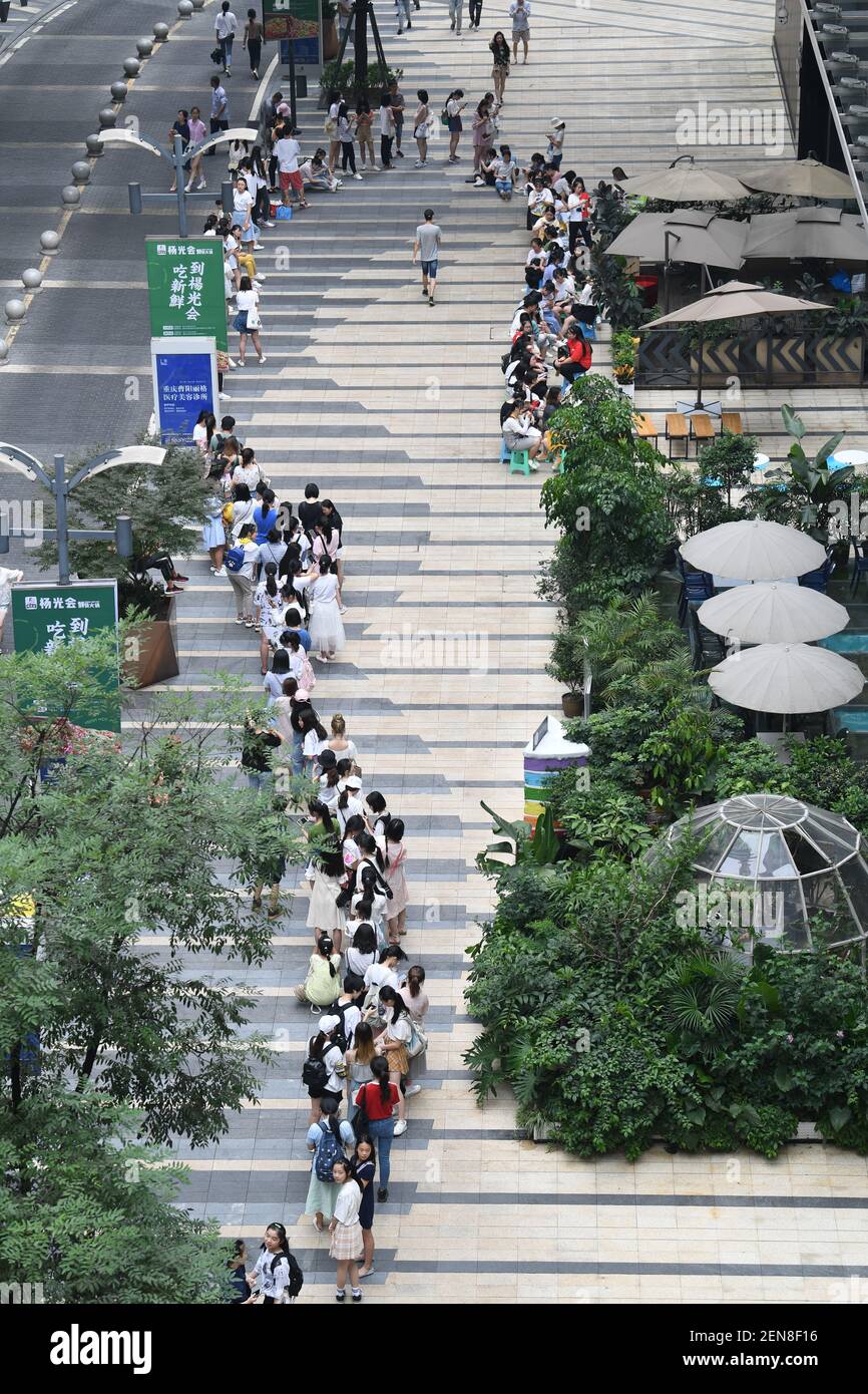 Chinese fans wait in a long queue in front of a milk tea store operated ...