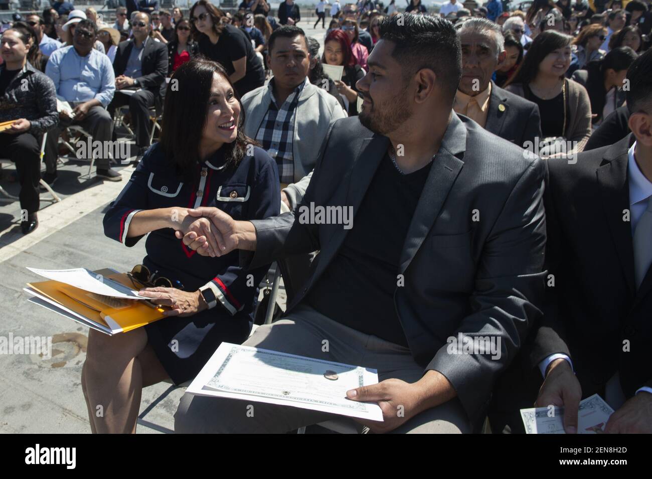 New U.S. citizens congratulate each other after the USCIS held 4th of ...