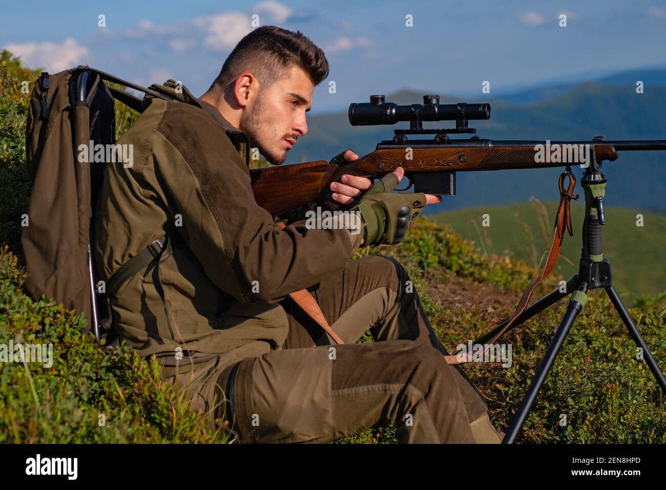 Man on the hunt. Poacher in the Forest. Hunter with shotgun gun after a ...