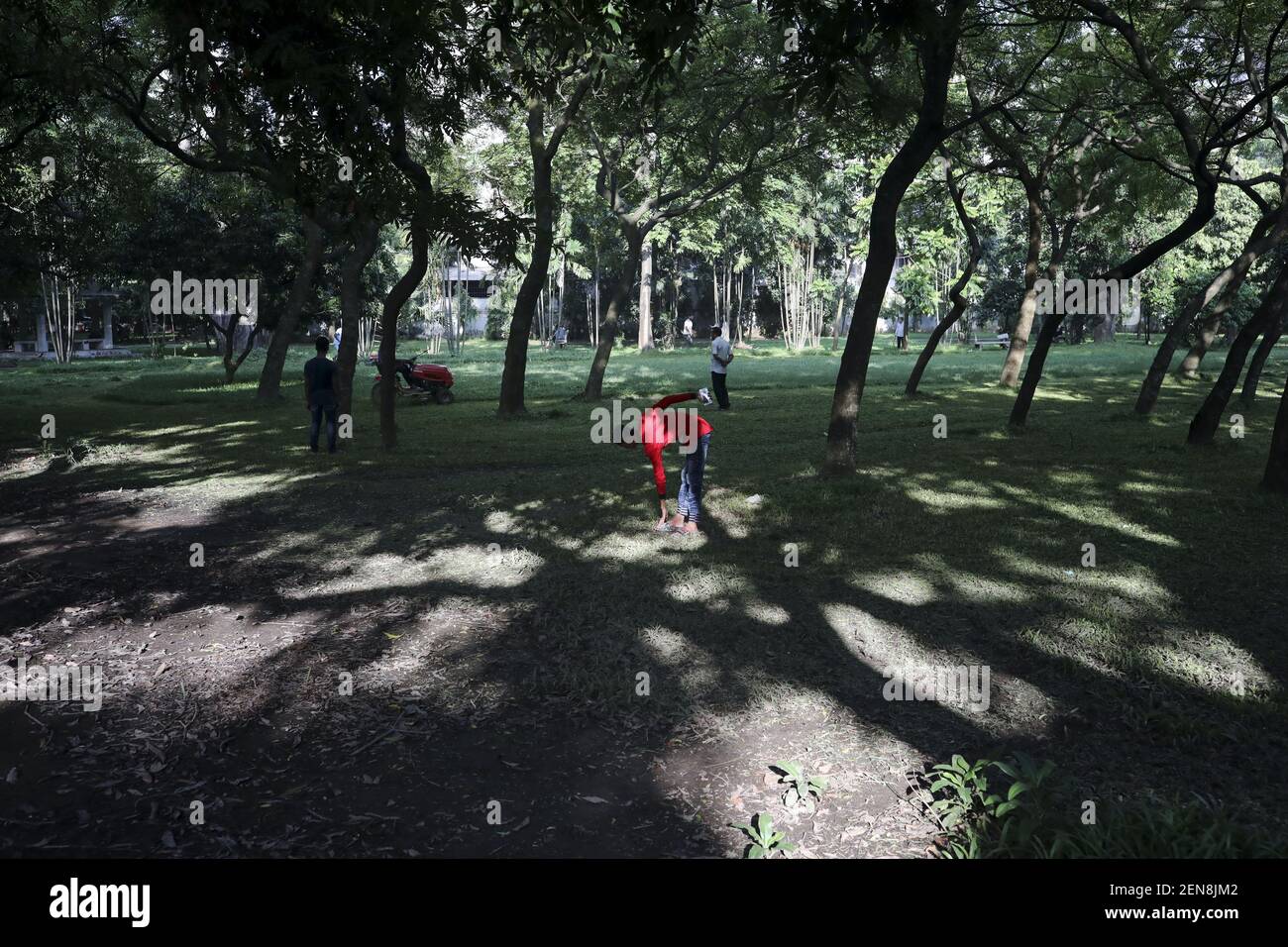 A boy is doing physical exercise at Ramna Park in Dhaka, Bangladesh on ...