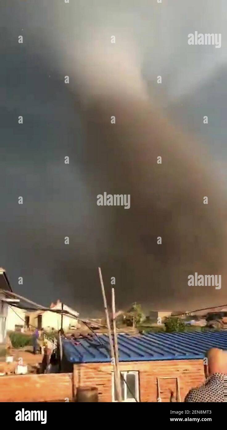 A tornado sweeps through residential buildings and streets in Kaiyuan ...