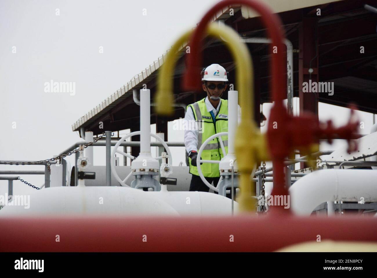 Indonesian workers PT. Pertamina checks aircraft fuel before it is ...