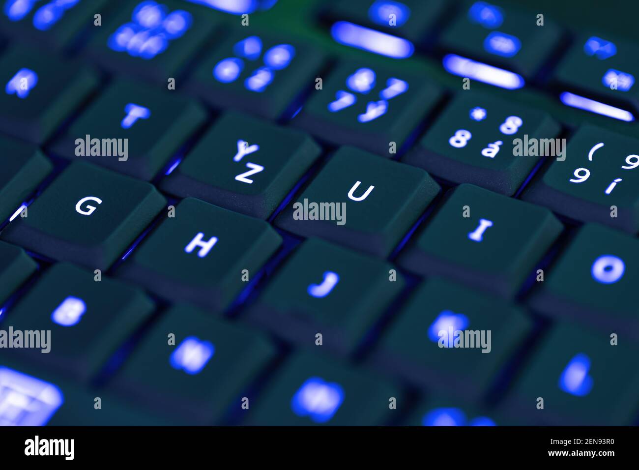 Closeup of laptop or desktop computer keyboard illumination, blue ...
