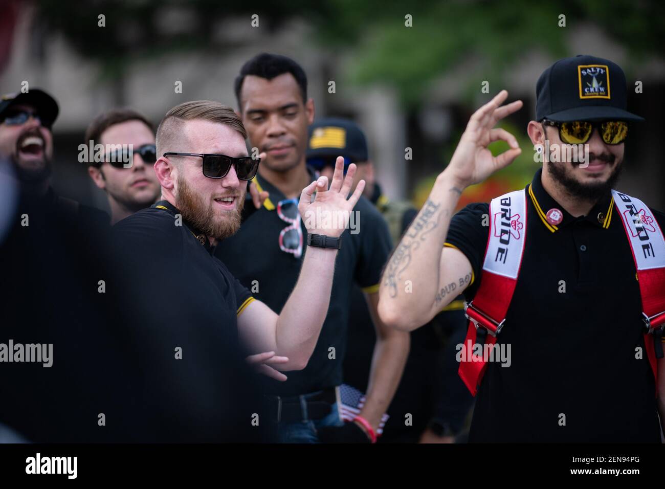 Members of the "Proud Boys" flash a white power symbol at the "Demand ...
