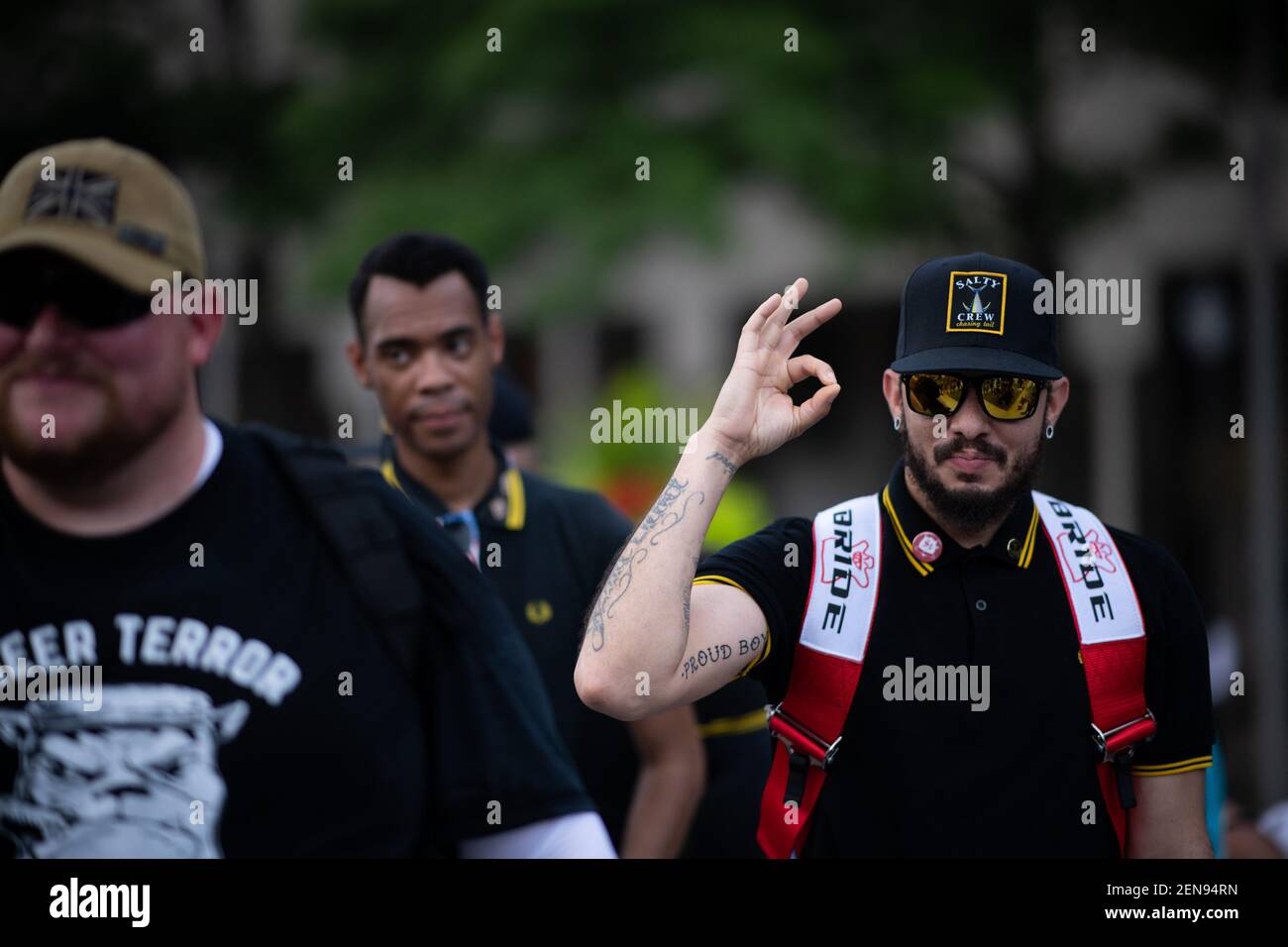 Members of the "Proud Boys" flash a white power symbol at the "Demand ...