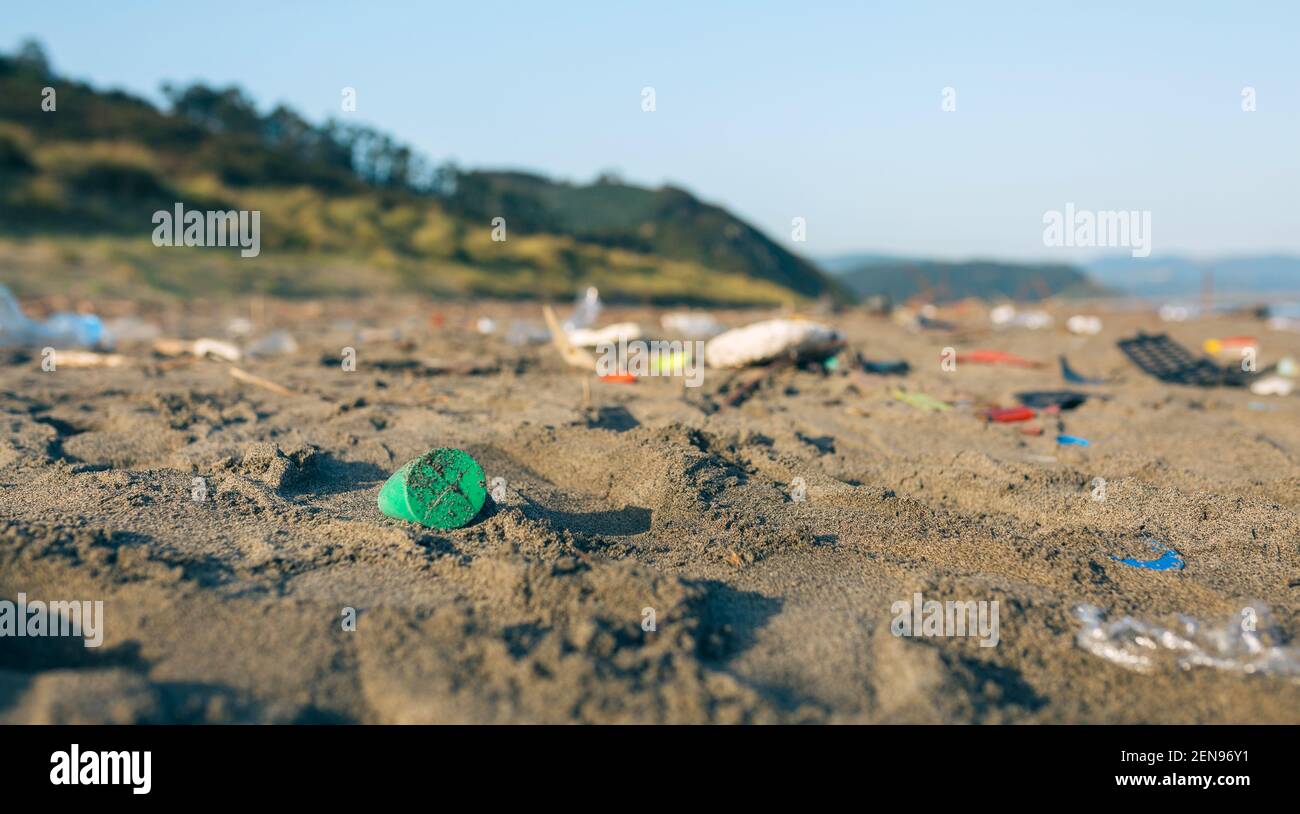 Dirty beach landscape full of waste Stock Photo - Alamy