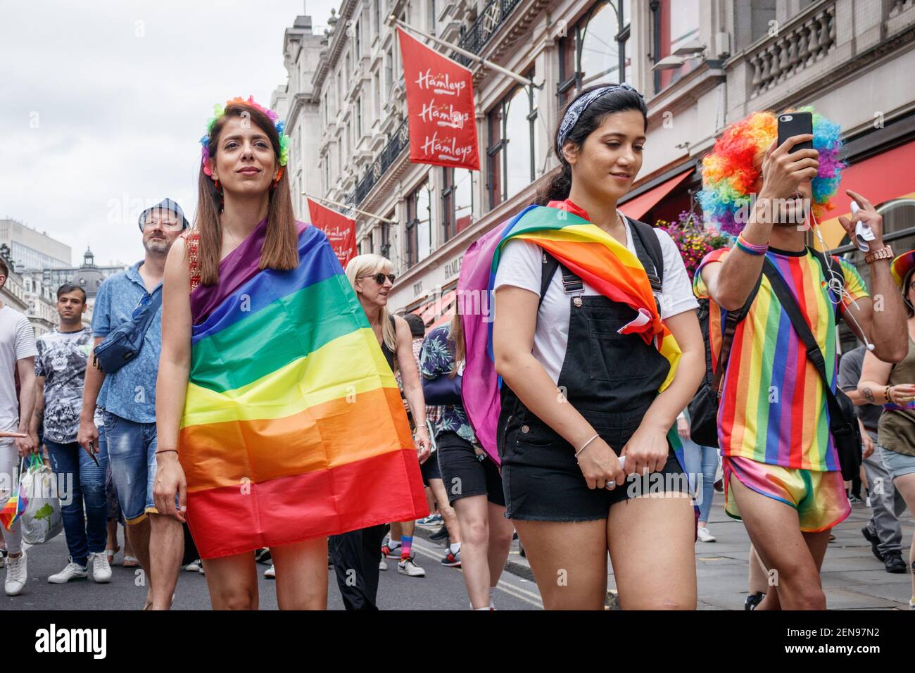 Girls wrapped in rainbow flags along Oxford Circus during the parade ...