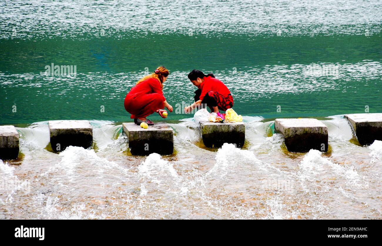 Tourists have fun as they walk on the Shui Ding Bu Path across the ...