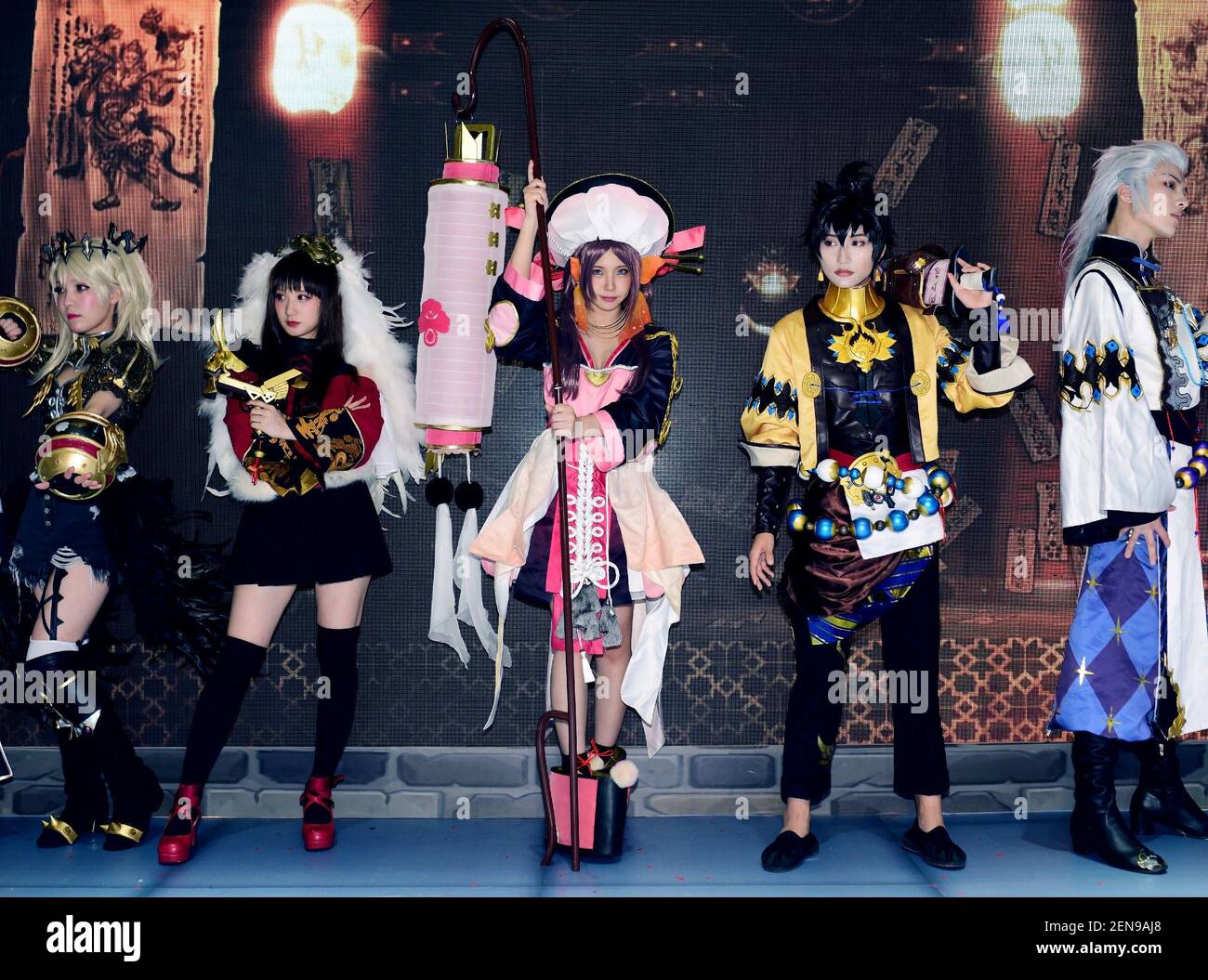 Young girls and boys dressed in cosplay costumes pose during the 15th ...