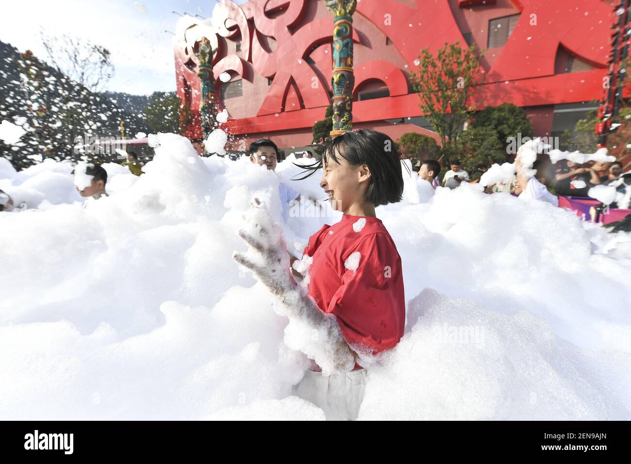 More than hundreds of tourists and local residents enjoy a bubble run ...