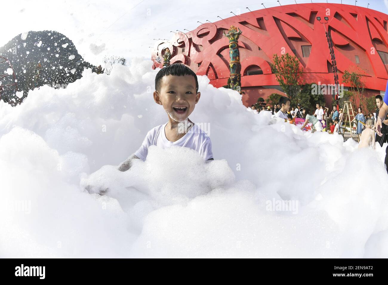 More than hundreds of tourists and local residents enjoy a bubble run ...
