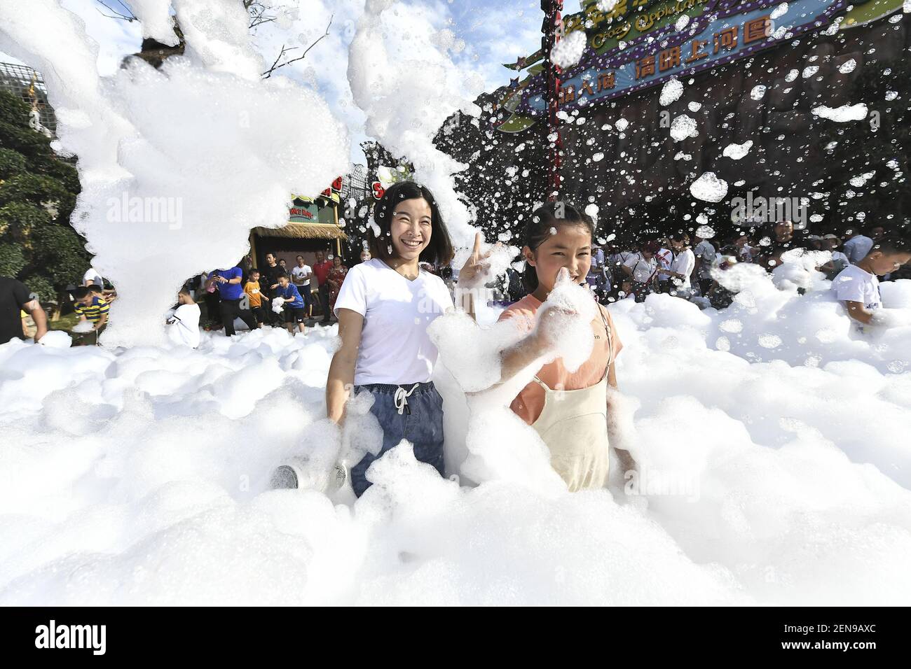 More than hundreds of tourists and local residents enjoy a bubble run ...