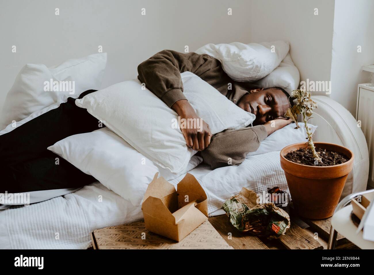 Man lying on bed hi-res stock photography and images - Alamy