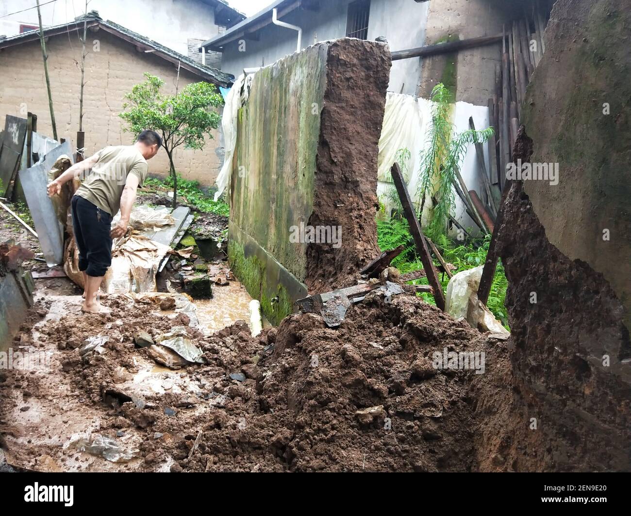 A residential building is collapsed by floodwater caused by a heavy ...