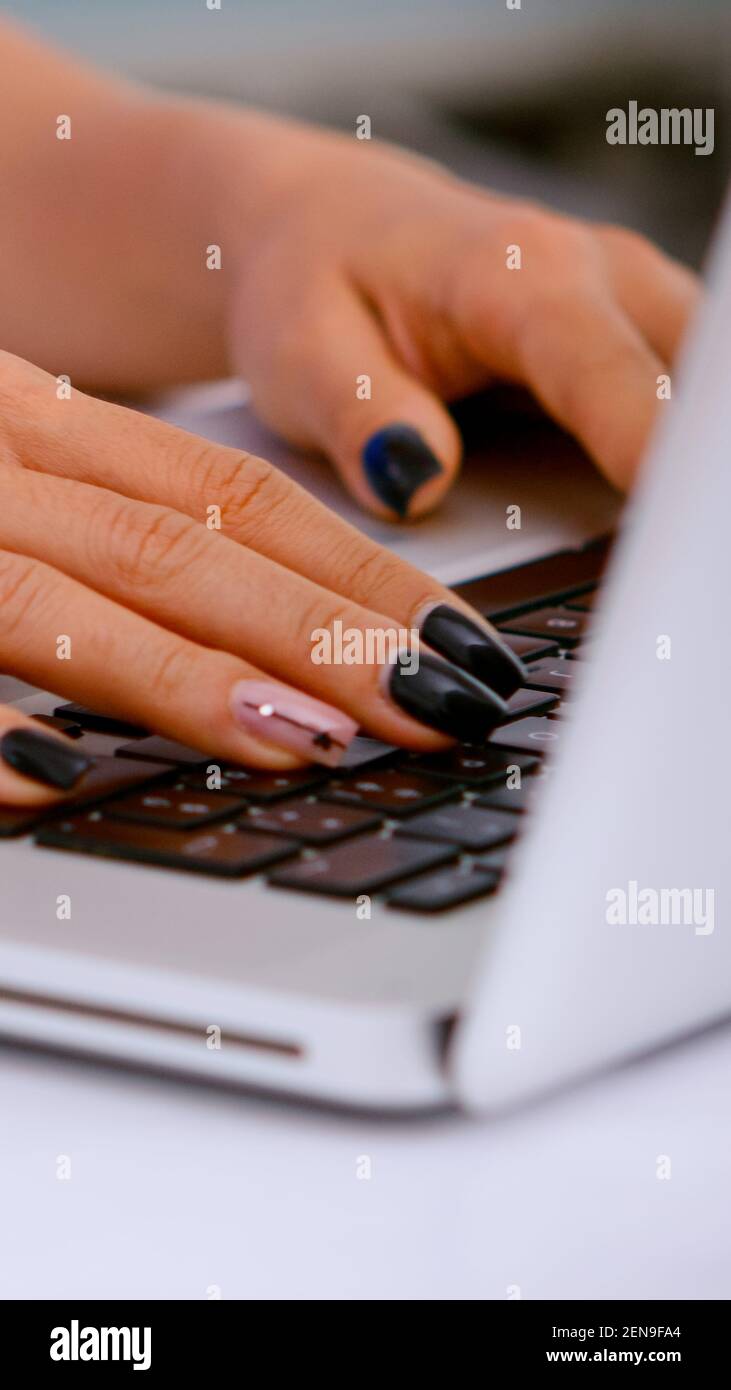 Close up of woman nurse typing patient health report on laptop keyboard ...
