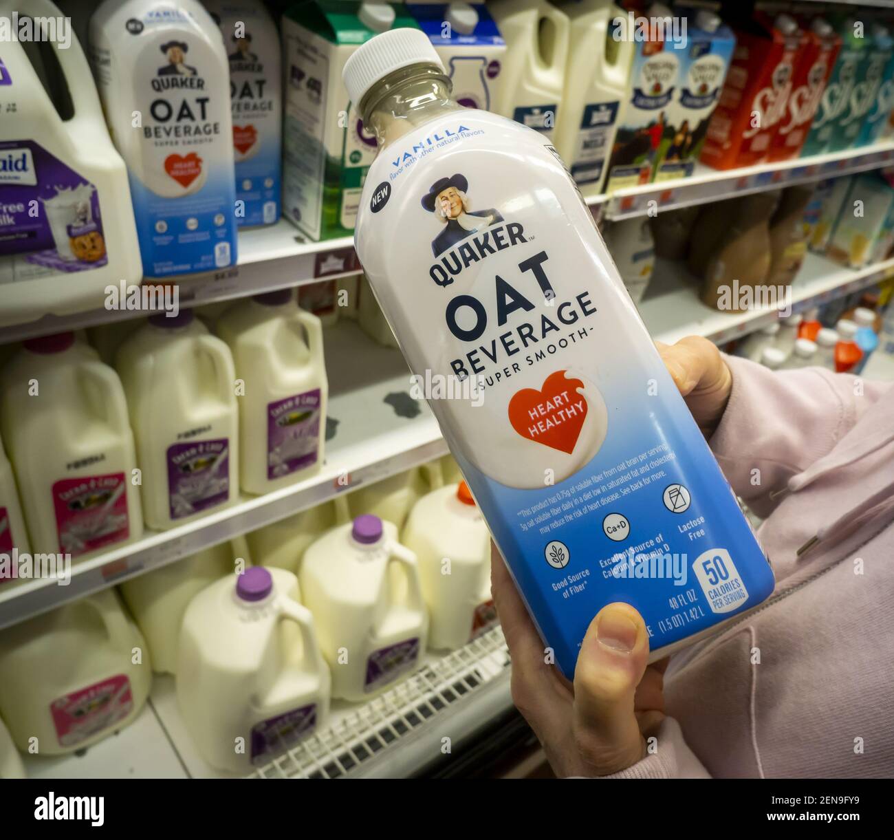 A discerning consumer chooses a container of Quaker brand oat-beverage ...