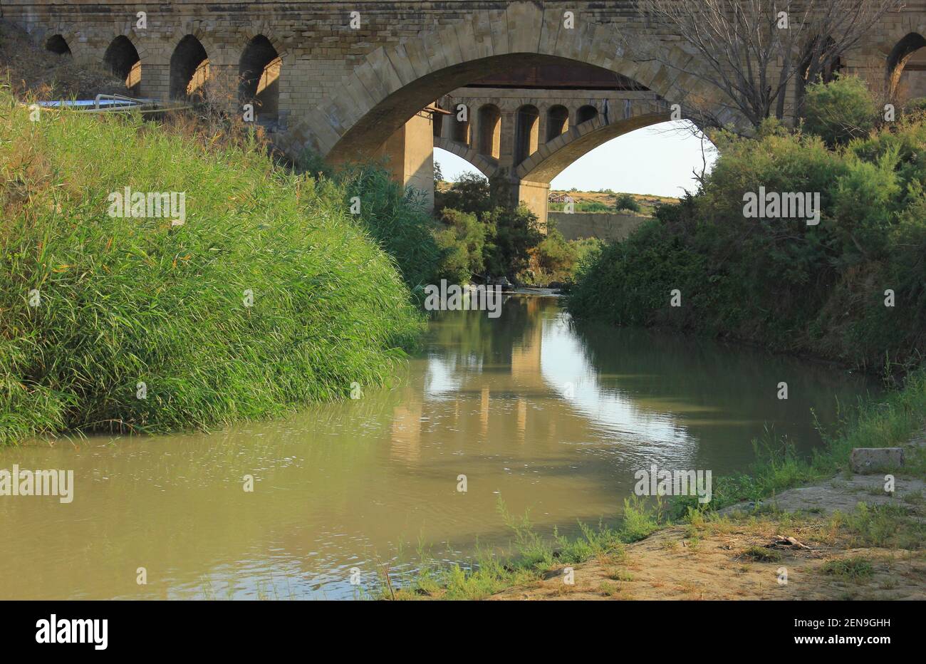 The river flows under a beautiful bridge Stock Photo - Alamy