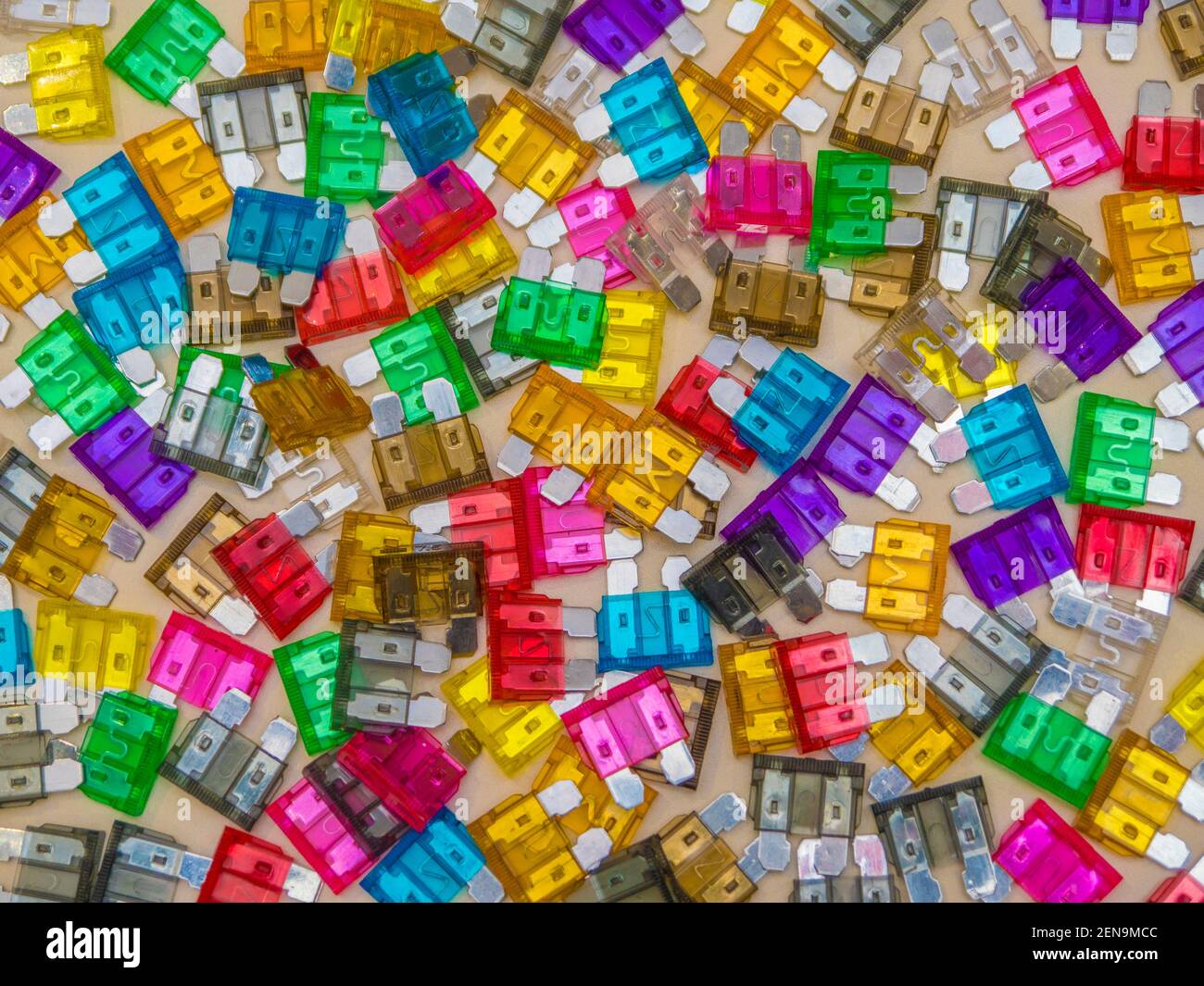 Closeup pov shot of a variety of vehicle blade fuses spread out on a ...