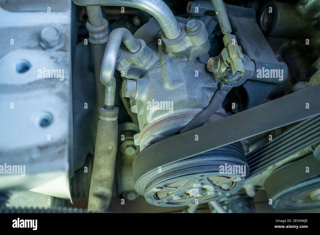 detail of the engine fragment include ac compressor belt and pulley ...