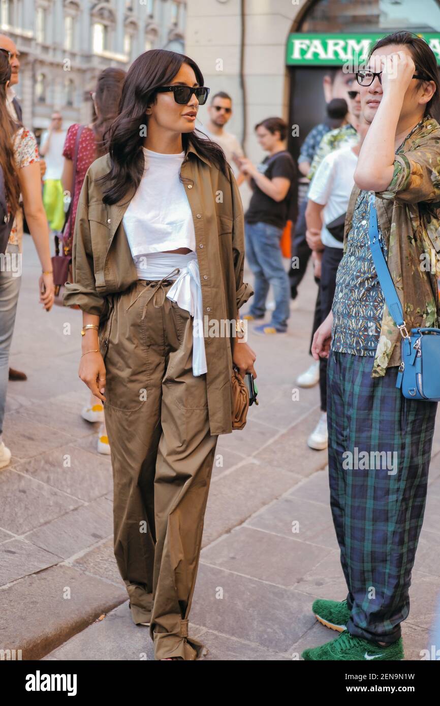 Trendy women and men pose for street snap during the Milan Fashion Week ...
