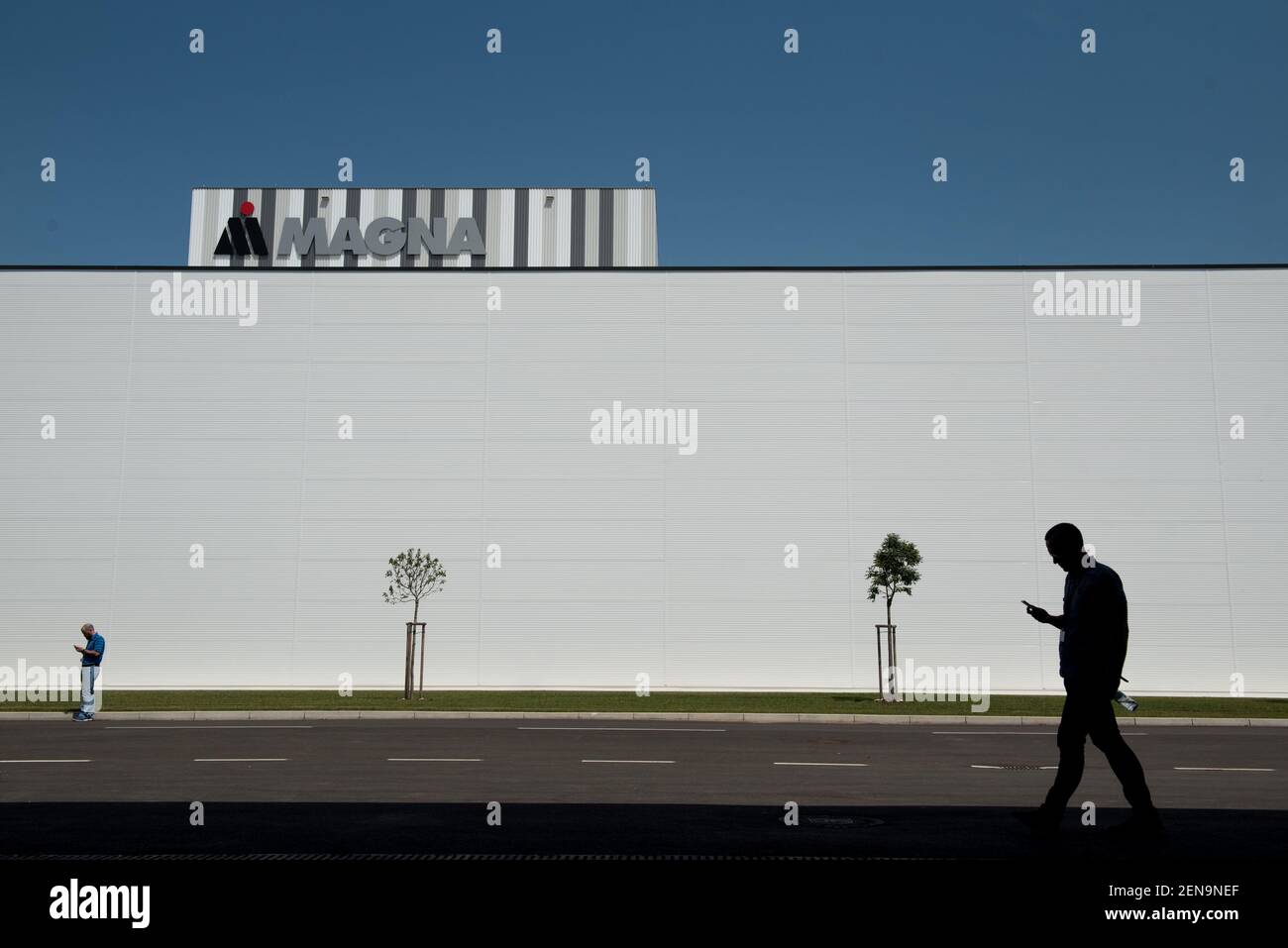 People with phones are pictured in front of Magna Steyr new paint shop ...