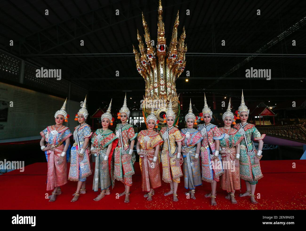 Traditional Thai performers poses in front of a royal barge after a ...