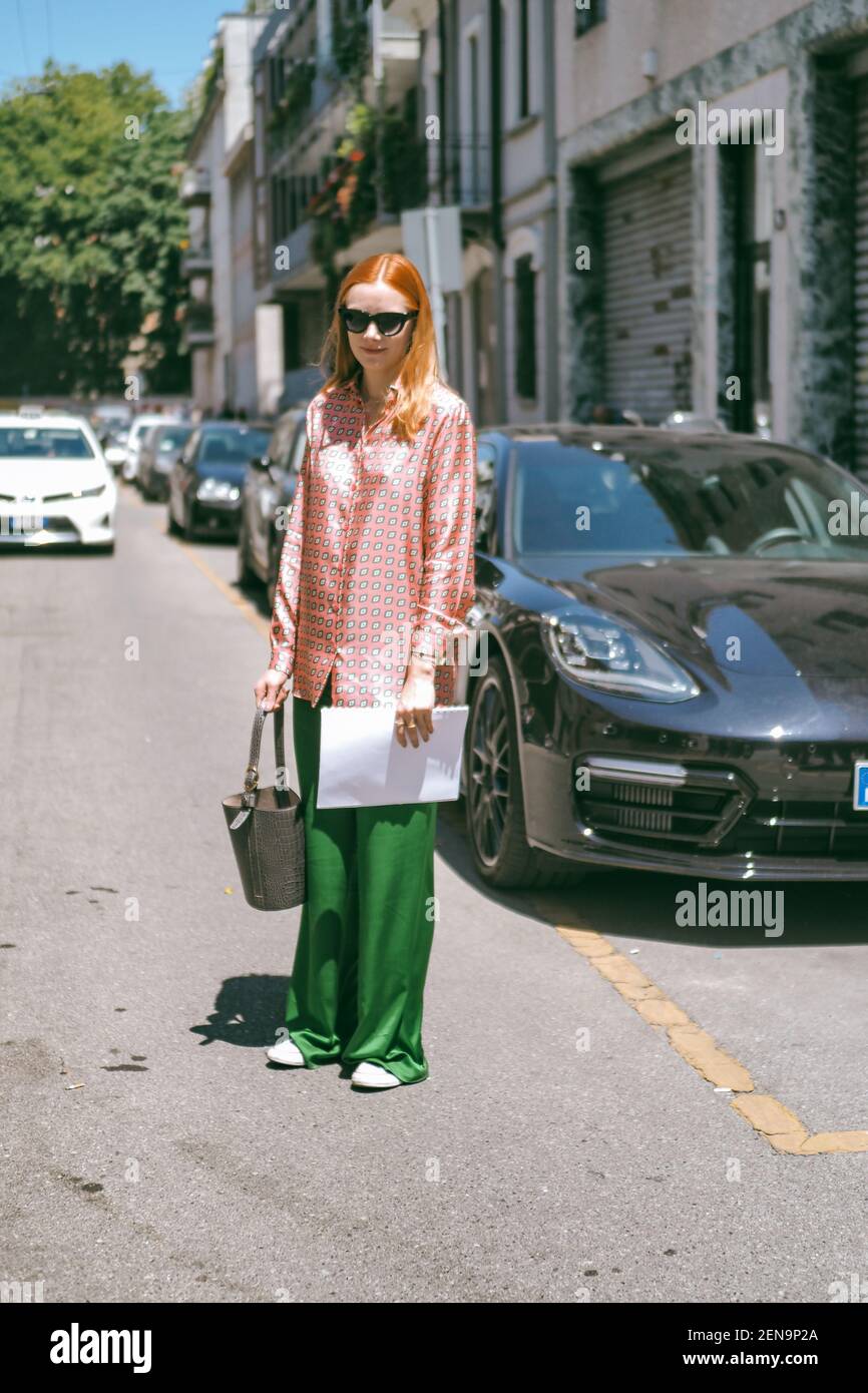 Trendy women and men pose for street snap during the Milan Fashion Week ...