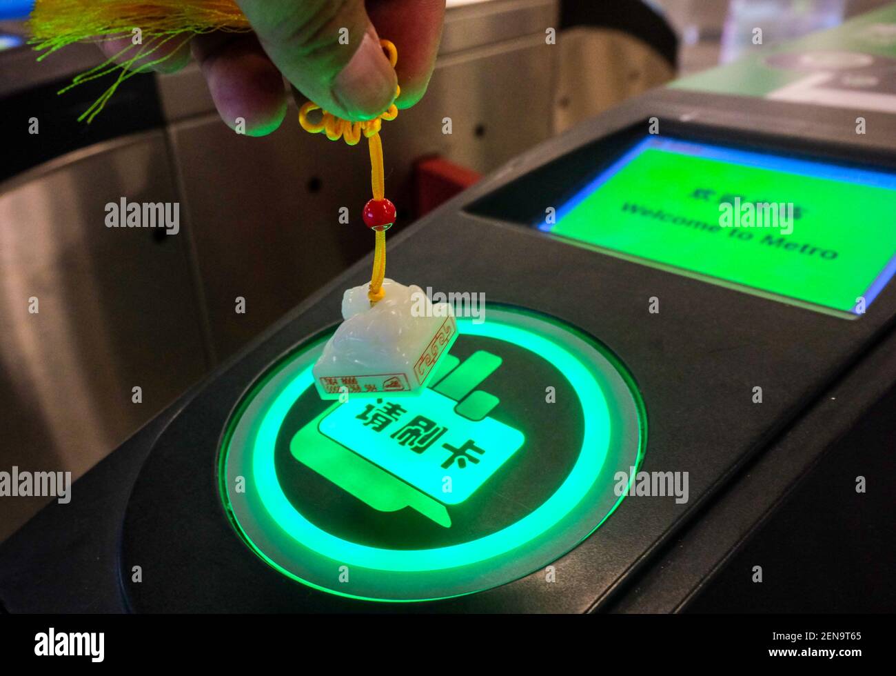 A passenger uses his Chang'an Tong public transport card featuring ...
