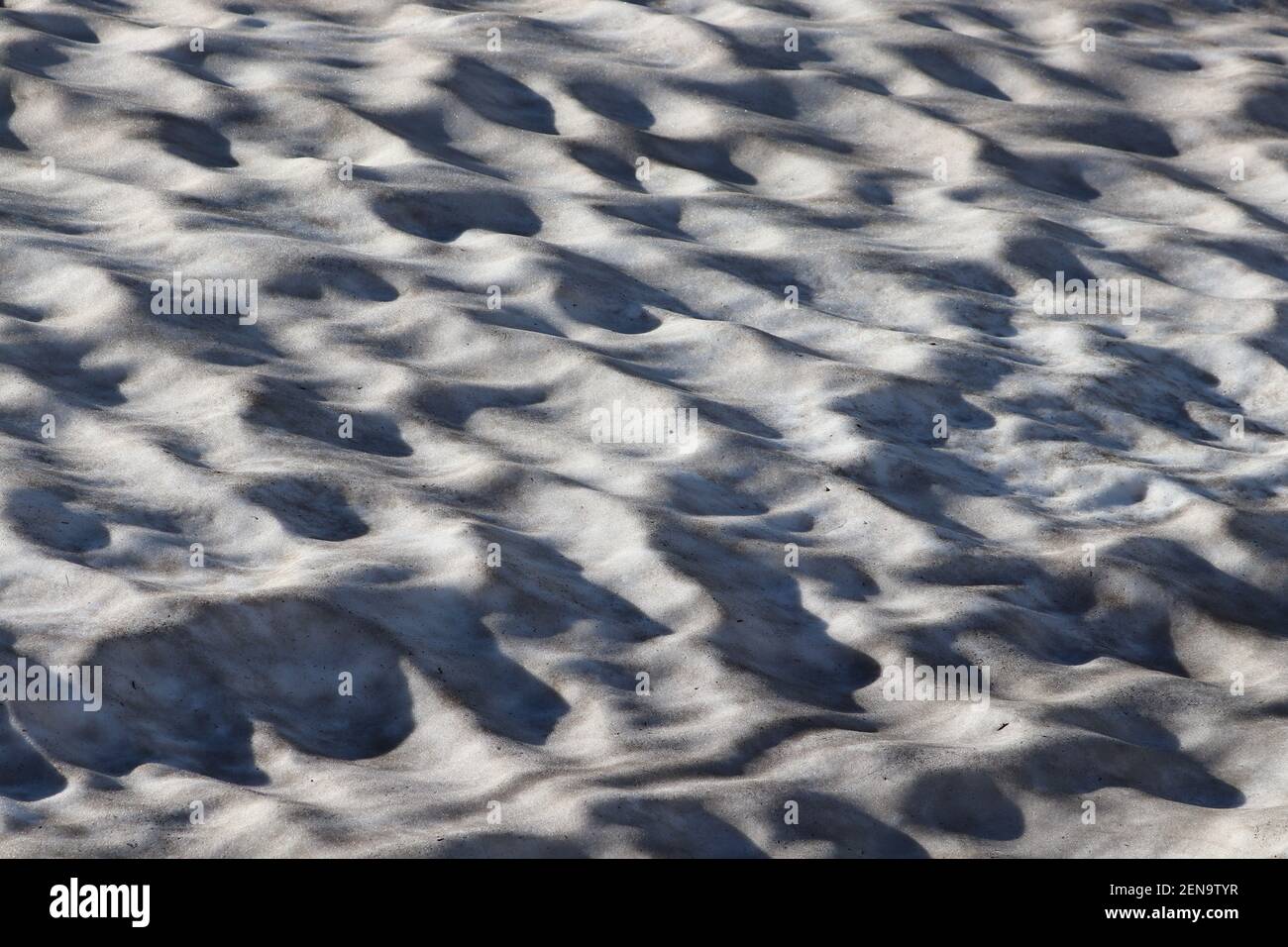Patterns in snow made by nature, day time Stock Photo - Alamy