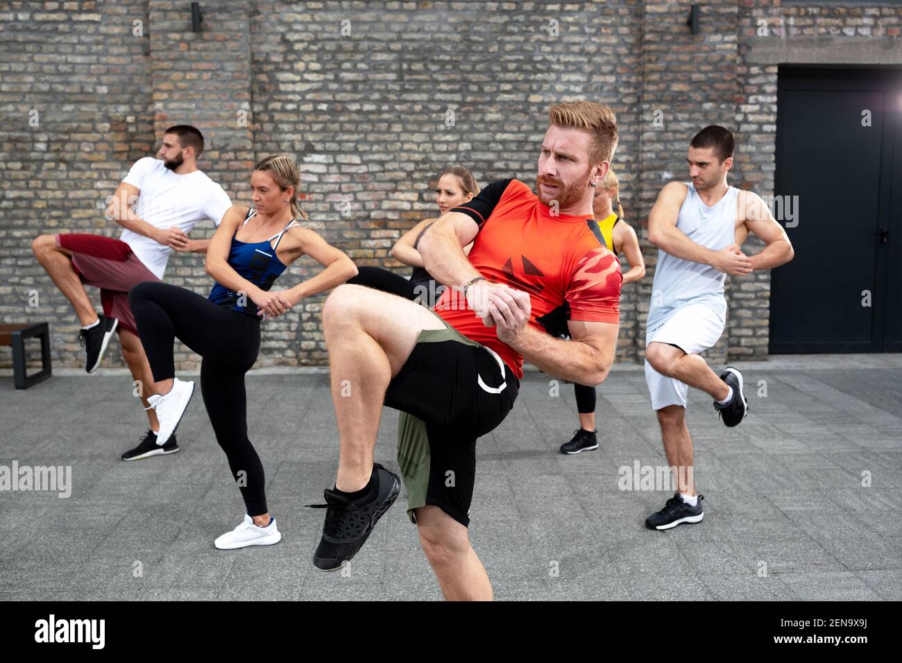Group of athletes practicing street fight martial arts, knee kick Stock ...