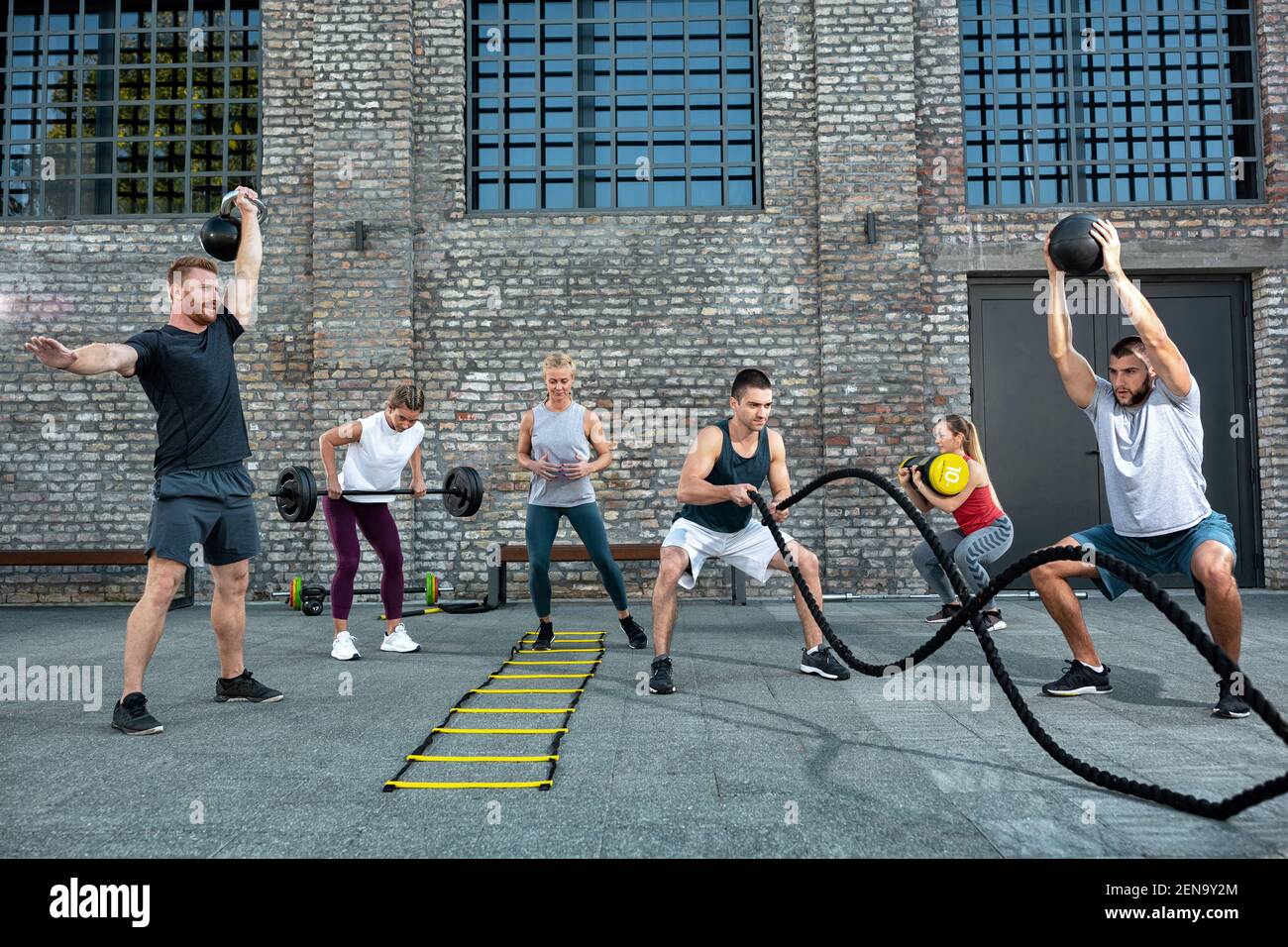 Group of healthy people working out, outside workout Stock Photo - Alamy