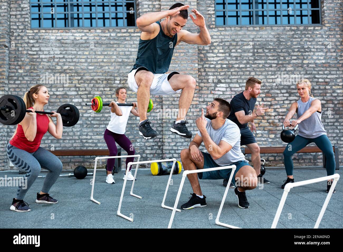 Woman jumping over hurdles hi-res stock photography and images - Alamy